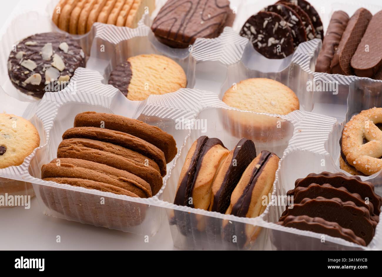 Different kinds of cookies in a plastic box. White background Stock ...