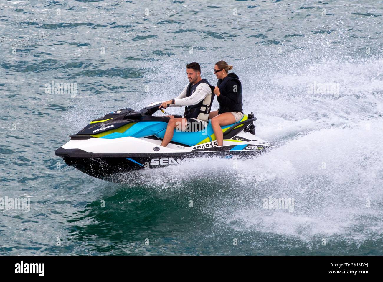 Young adults riding a Sea-Doo impeller-driven waterjet watercraft in ...
