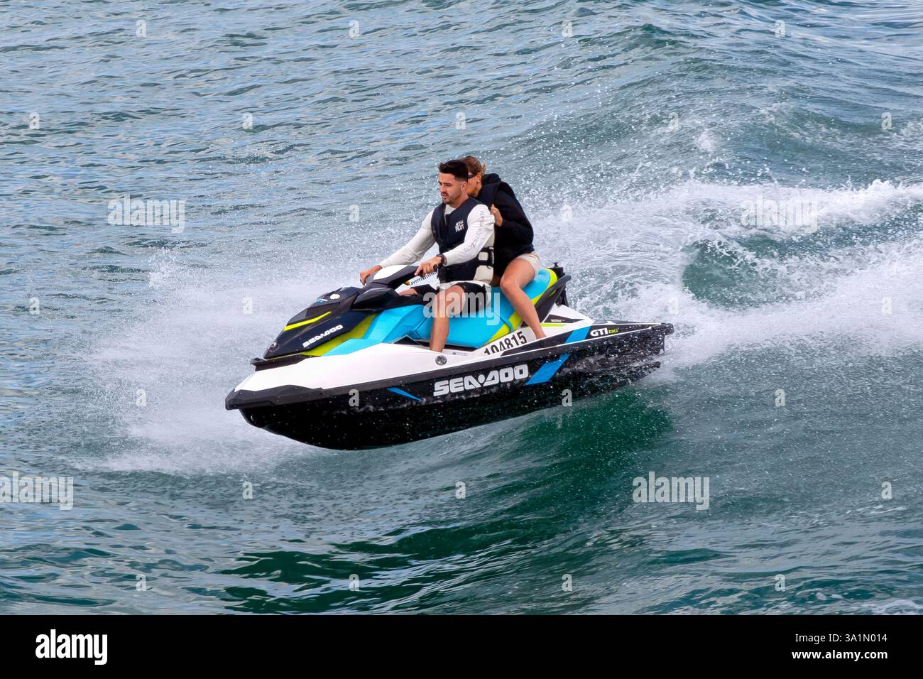 Young adults riding a Sea-Doo impeller-driven waterjet watercraft in ...