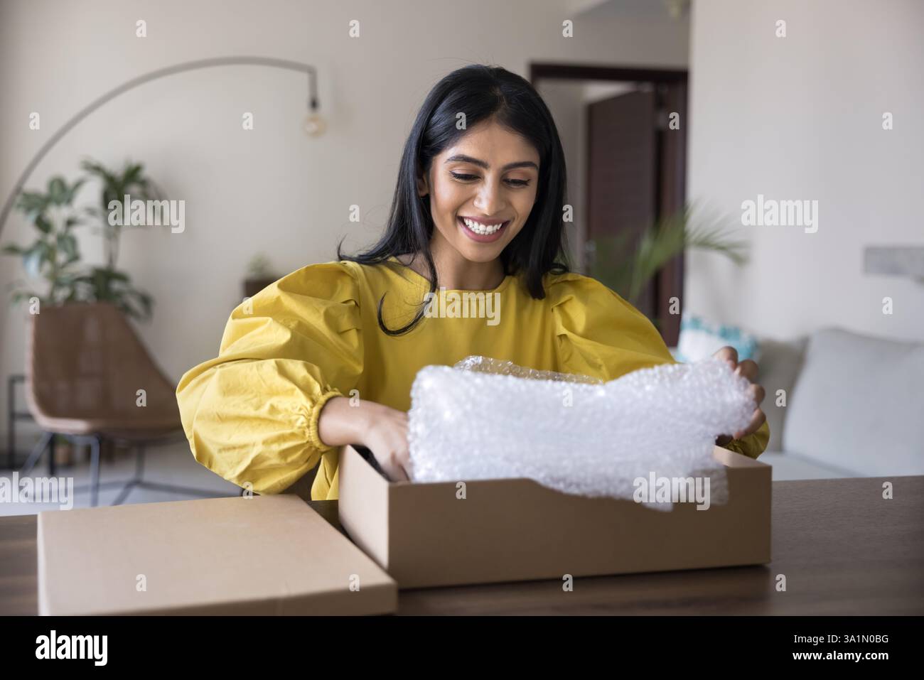 Happy indian woman unbox hi-res stock photography and images - Alamy