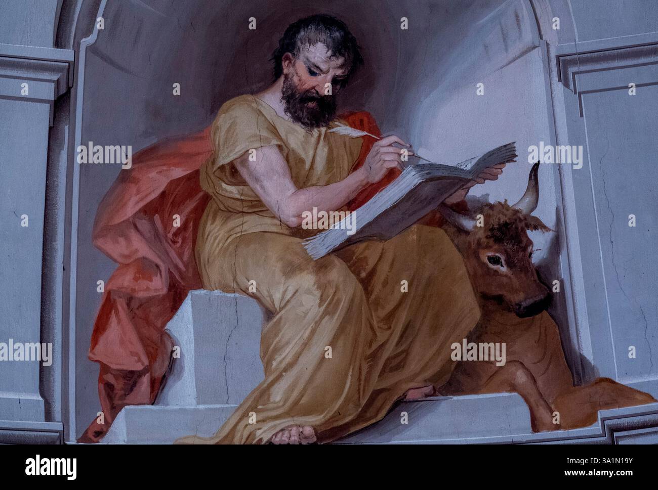 Puget Theniers, FRANCE, 02-17-2025: Fresco (19th century) of Saint Luke ... Puget Theniers, FRANCE, 02-17-2025: Fresco (19th century) of Saint Luke ...