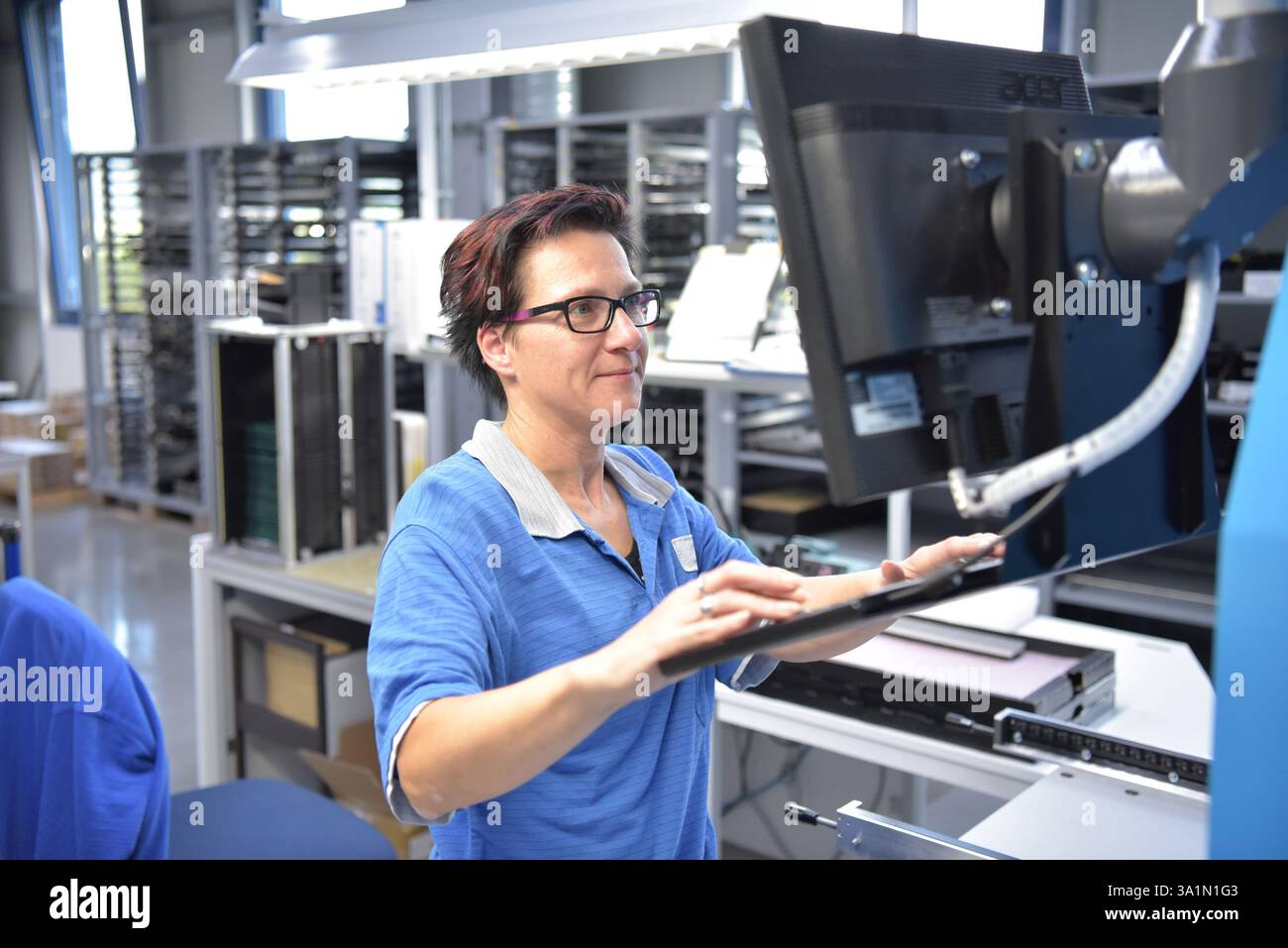 woman works in the production of a factory for electronics - operation ...