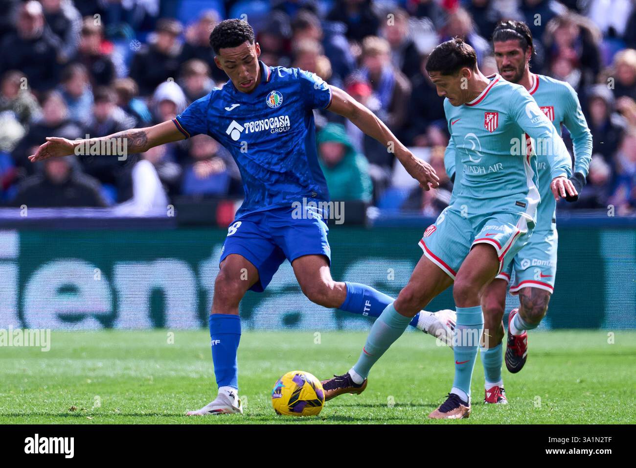 Alvaro Rodriguez of Getafe CF and Nahuel Molina of Atletico de Madrid ...