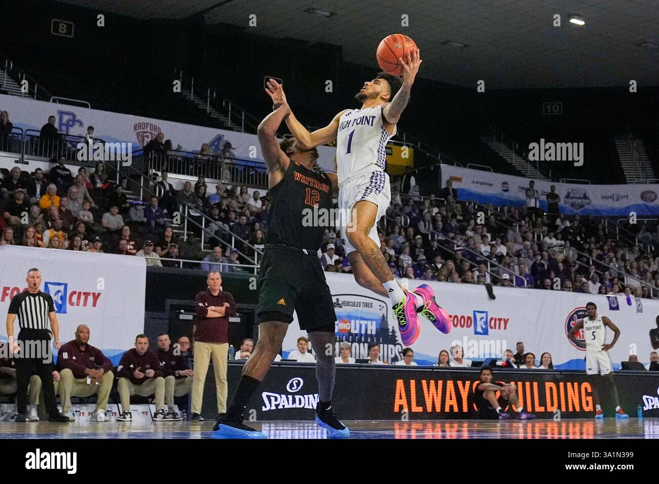 High Point guard Kezza Giffa (1) shoots the ball past Winthrop forward ...