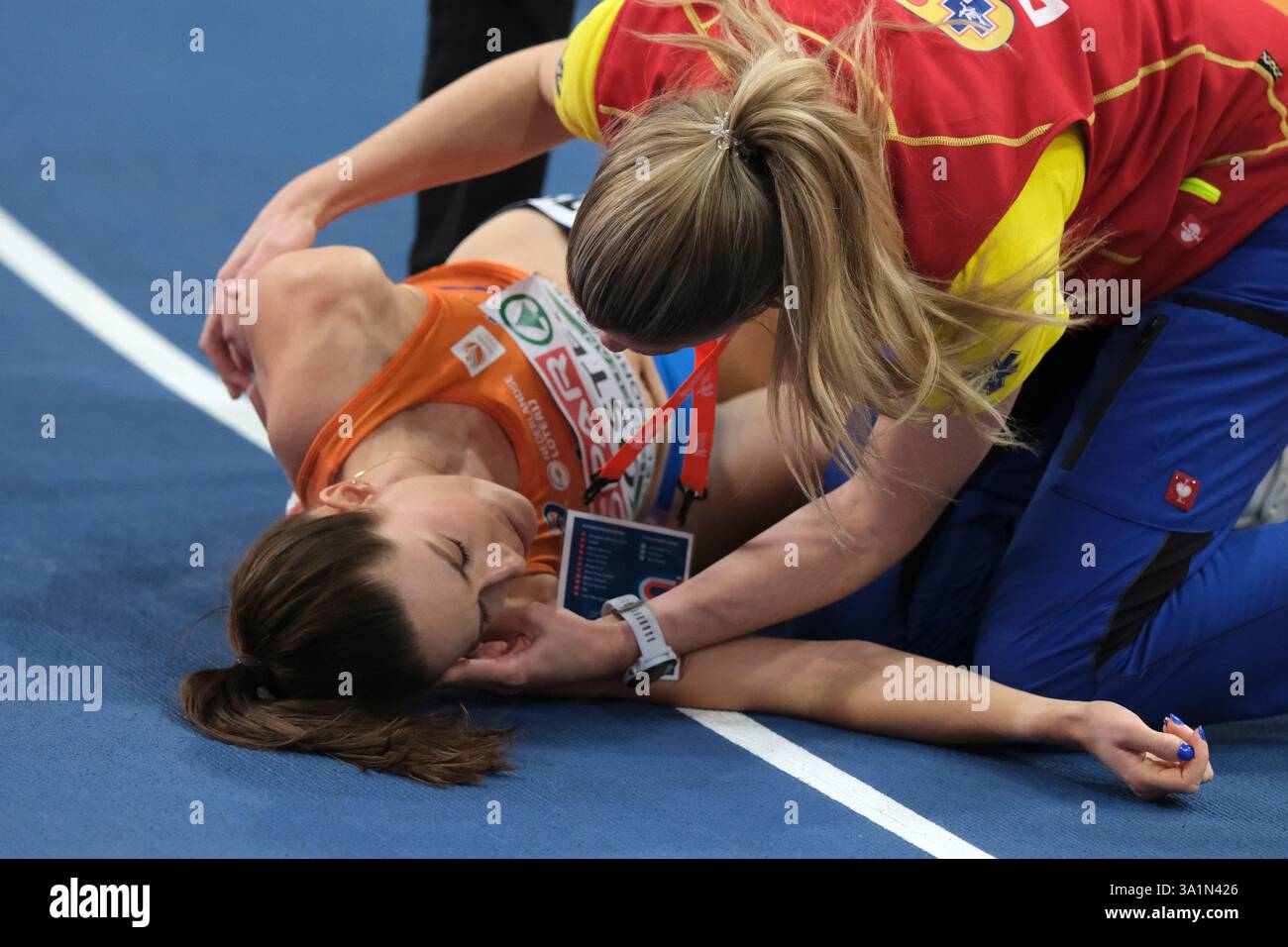 Netherlands' Maureen Koster, bottom, receives medical treatment during ...