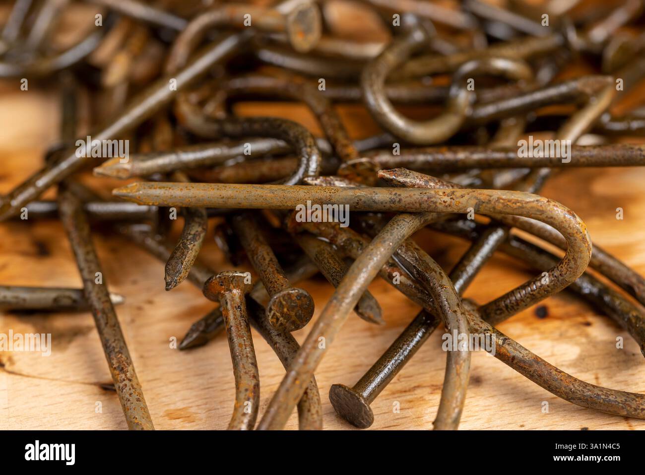 old broken and bent steel nails covered with rust, damaged metal nails ...