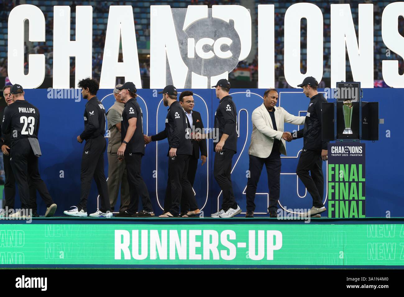 New Zealand players shake hands with the ICC officials on the podium ...