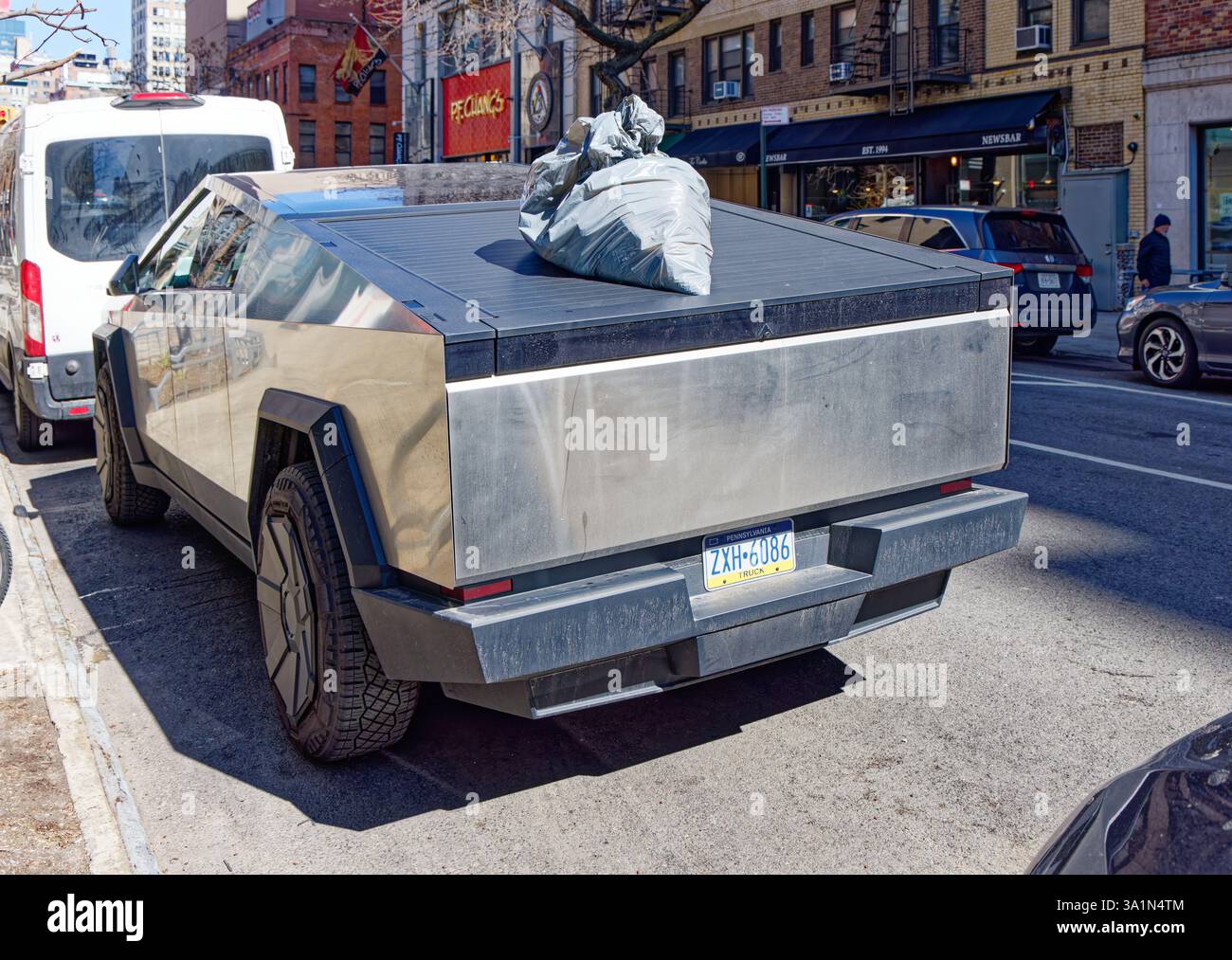 Garbage bag tossed on a Tesla Cybertruck in the aftermath of the ...