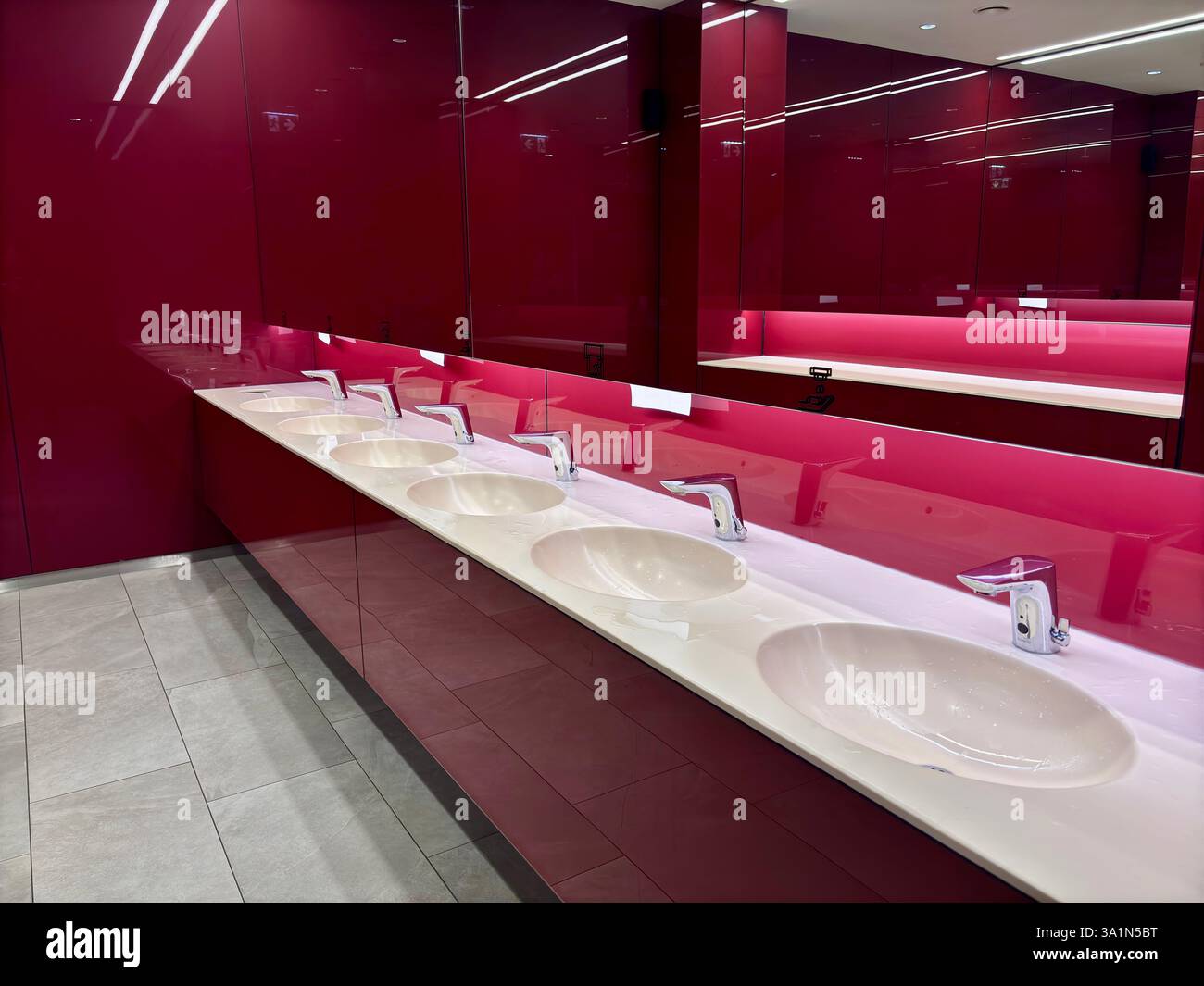Public Restroom Design in Red Tones with Washbasins Lamps and Light ...