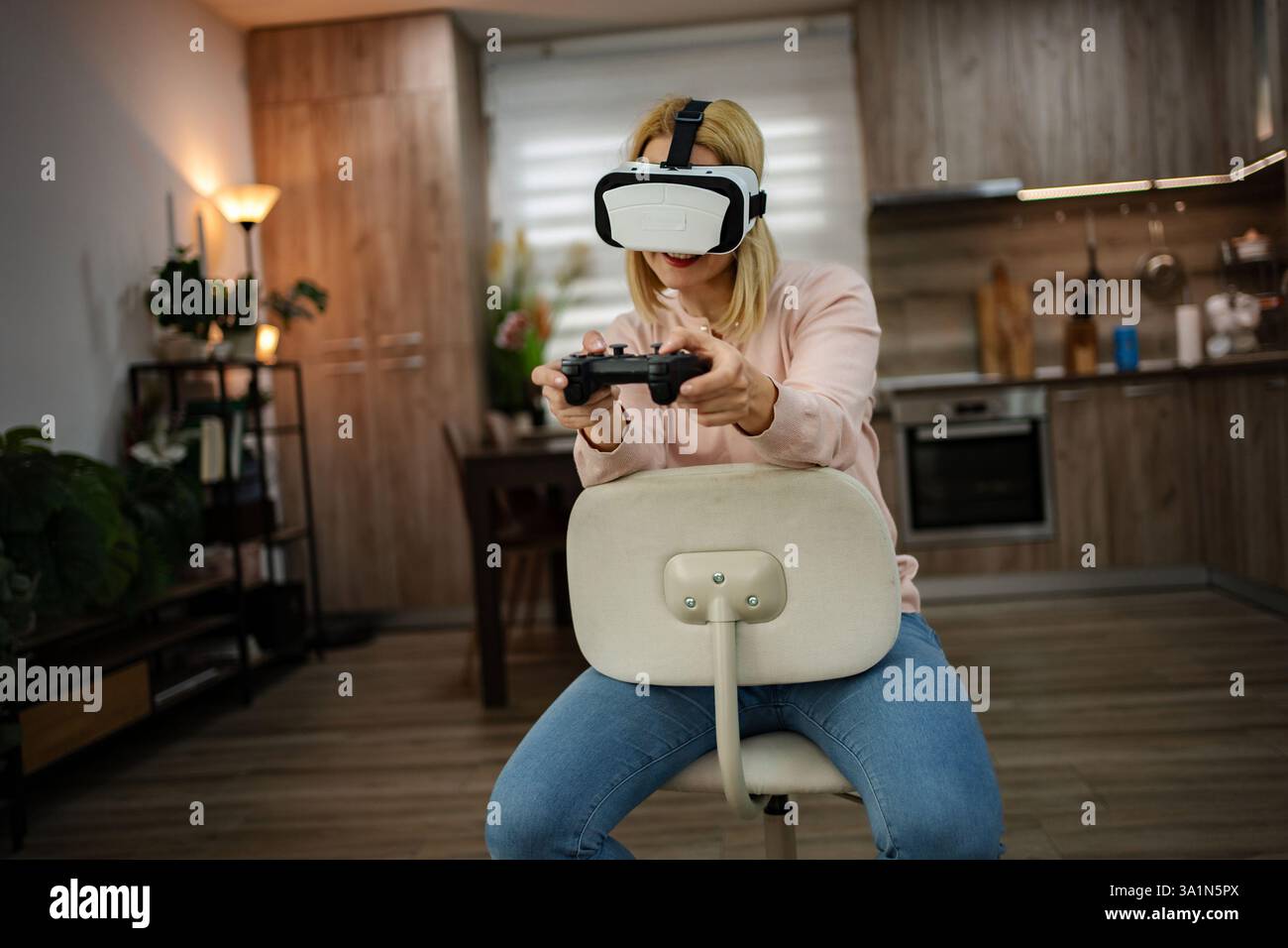 Virtual reality adventure unfolds in a cozy modern kitchen as a young ...