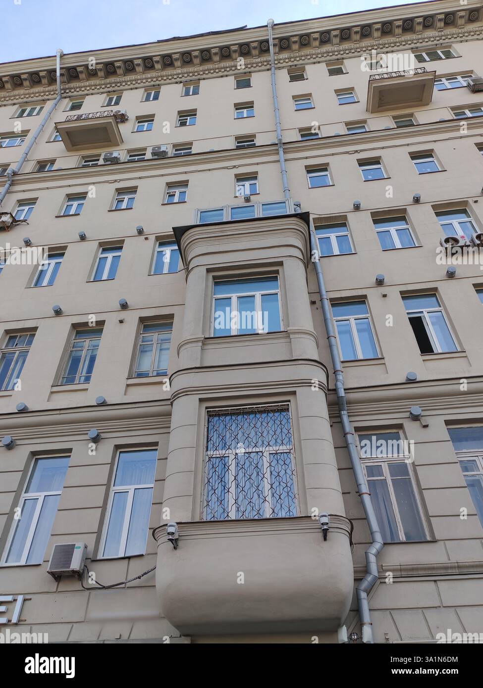 An urban apartment building featuring multiple small balconies, large ...