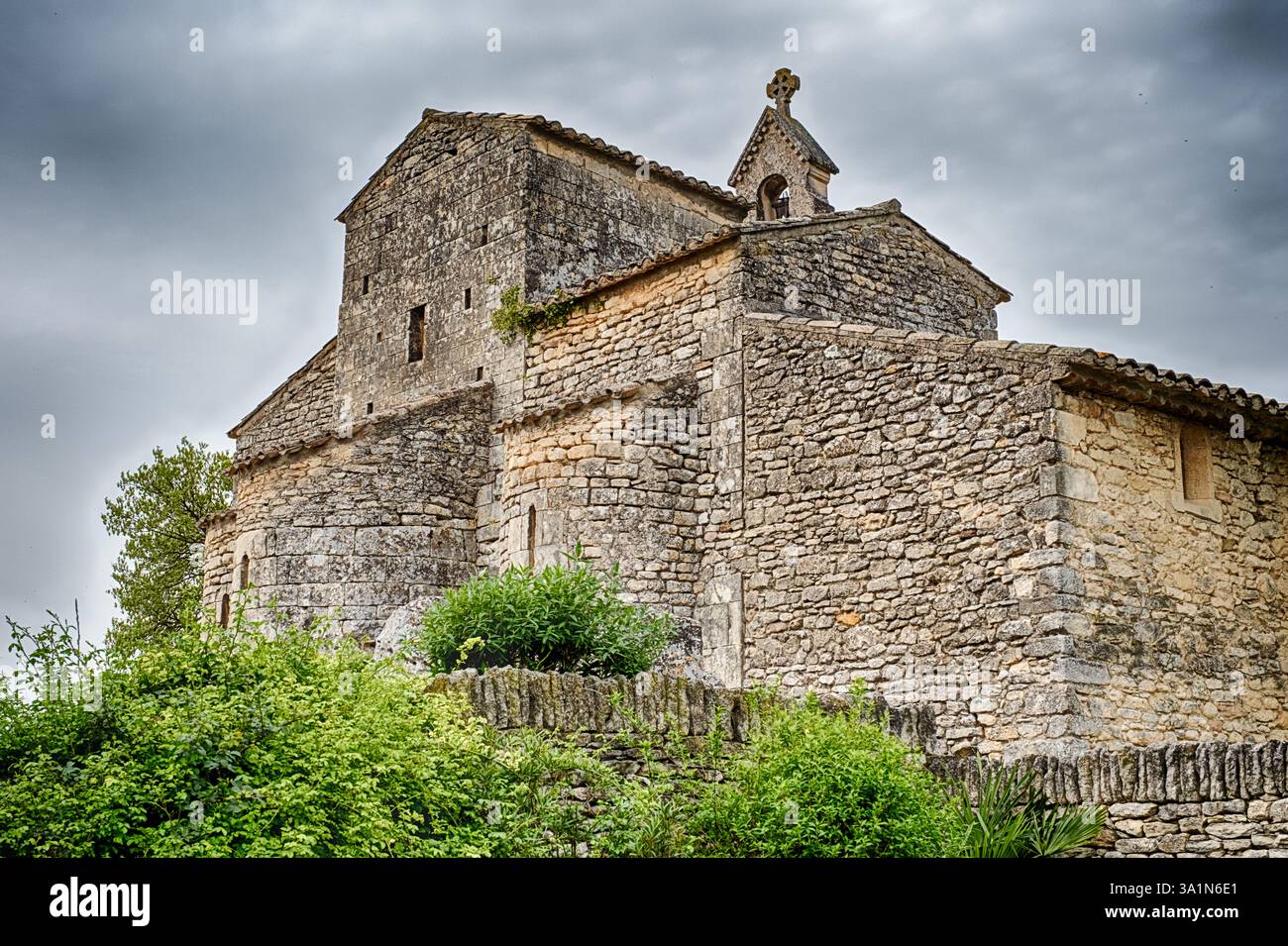 The old stone wall exterior of the Romanesque Church in St. Pantaleon ...