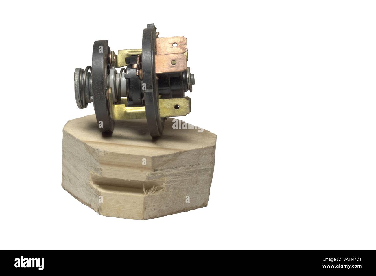 ignition starter switch. inner part with terminal set, on wooden stand ...