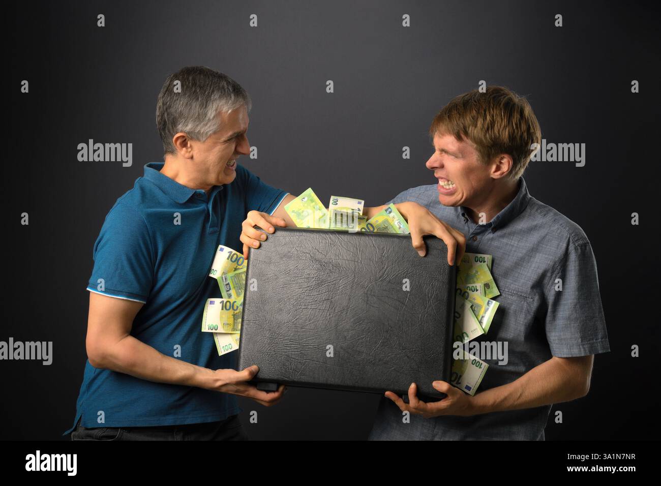 Finance concept shot with two angry people fighting over a suitcase ...
