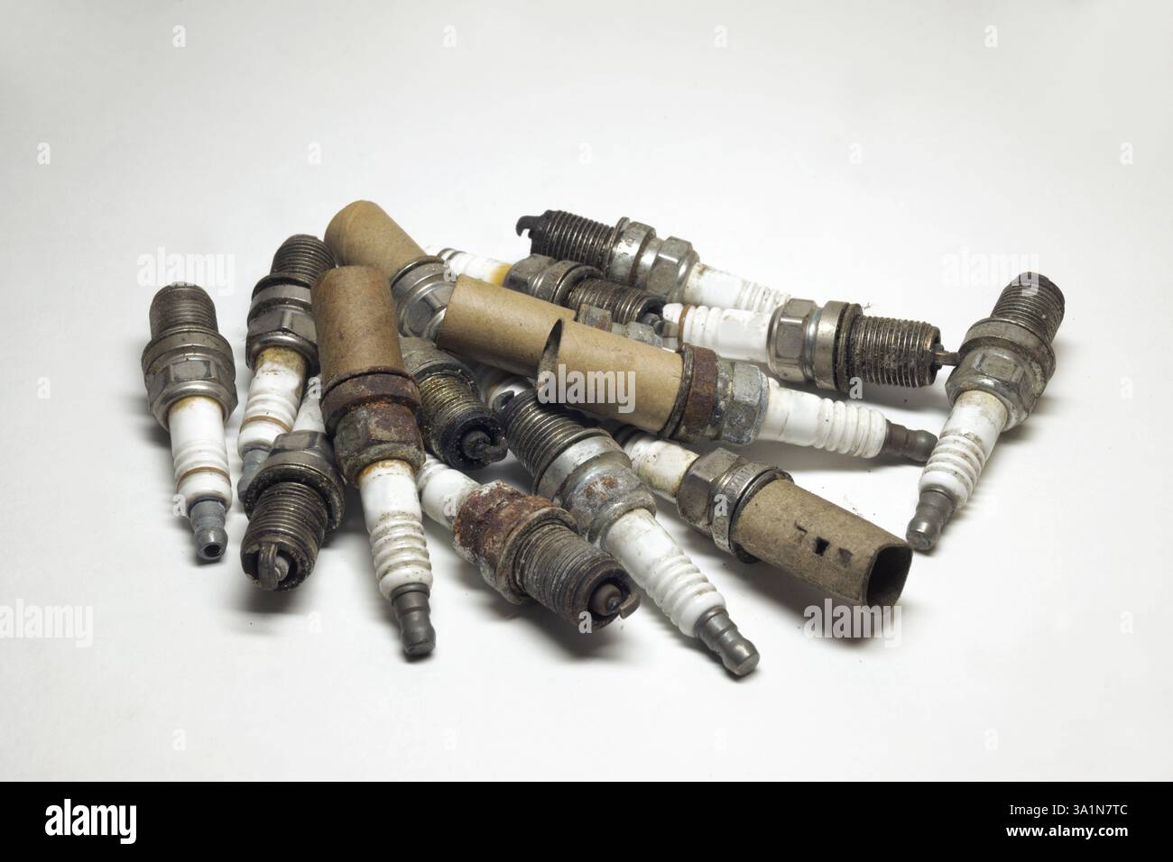 used copper spark plugs on white background. spark plugs big heap, old ...