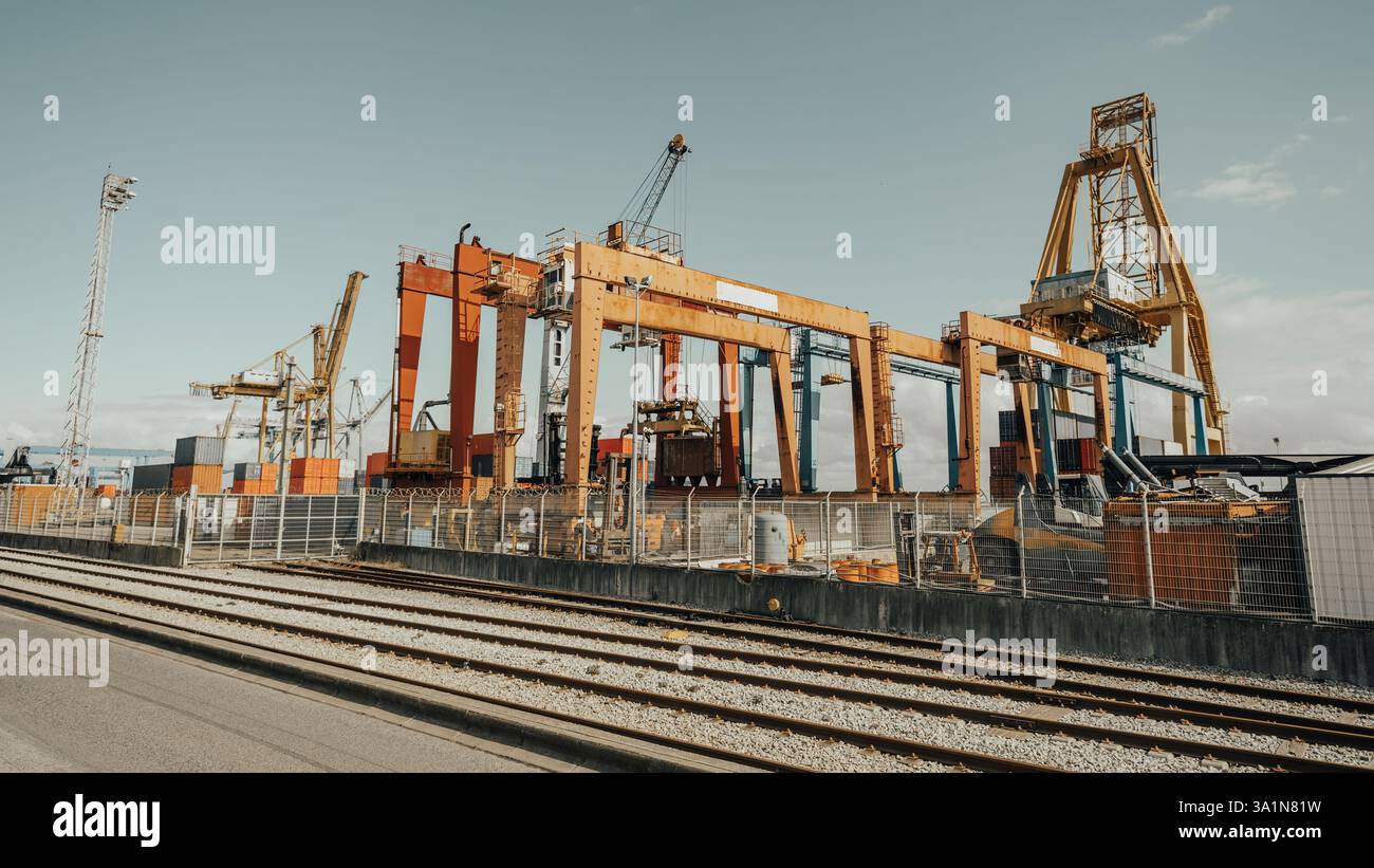 Large industrial port with multiple gantry cranes, shipping containers ...