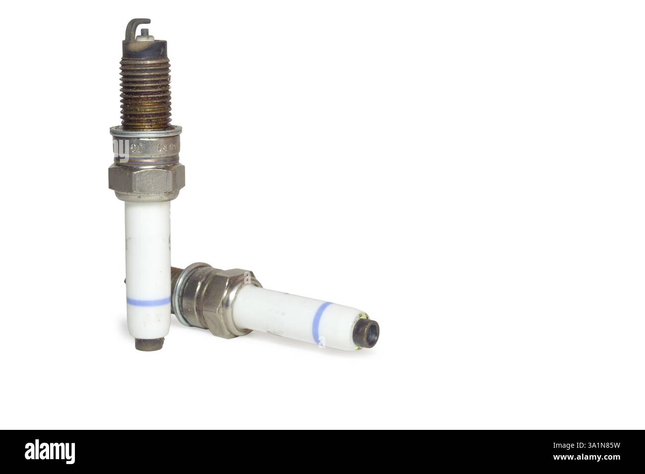 used spark plugs pair, blue strip on body of hite insulator. on white ...