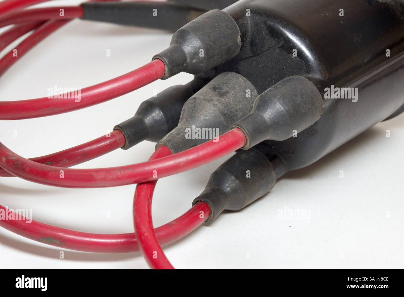 spark plug wires, red, high tension cables, close-up on rubber boots ...