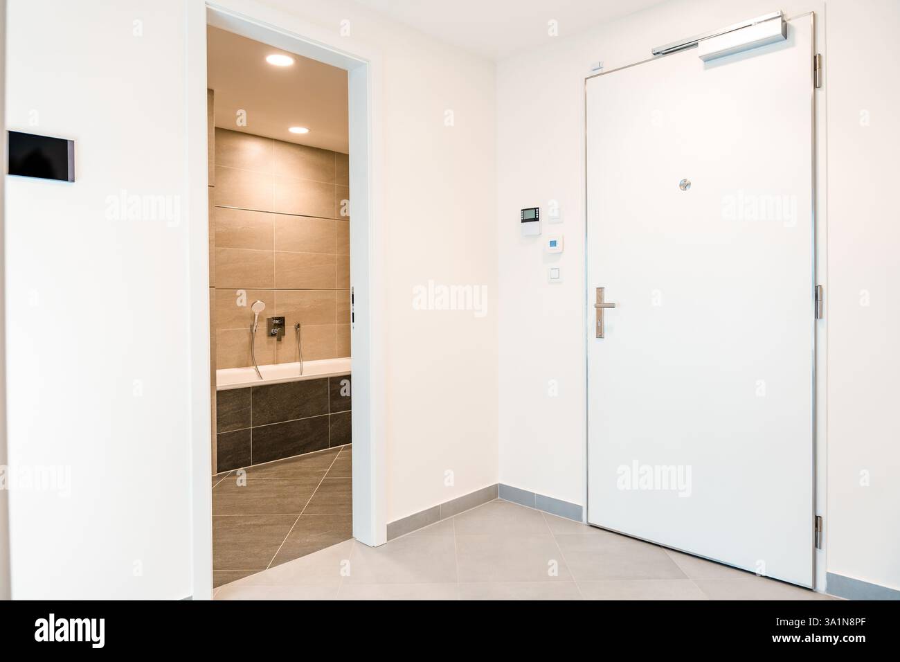 Bright modern home entrance with a white security door, smart home ...