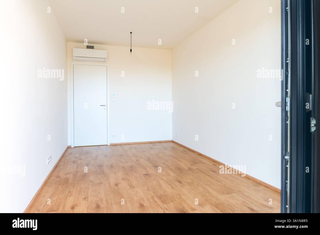 Minimalist empty room with air conditioning and wooden flooring in ...