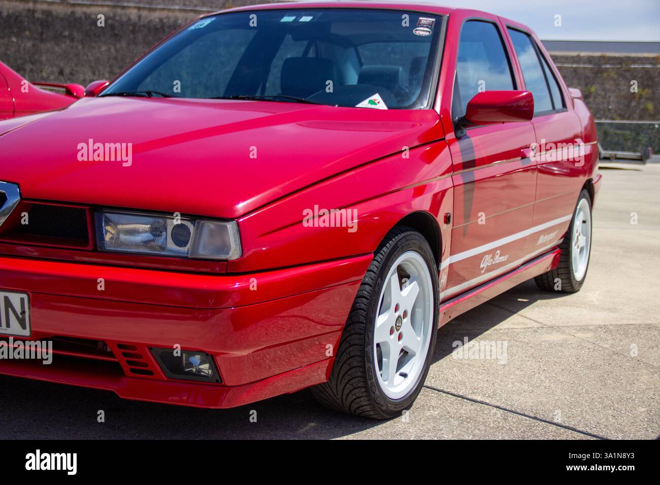 Shiny red alfa romeo 155 parked in a parking lot, showcasing its sporty ...