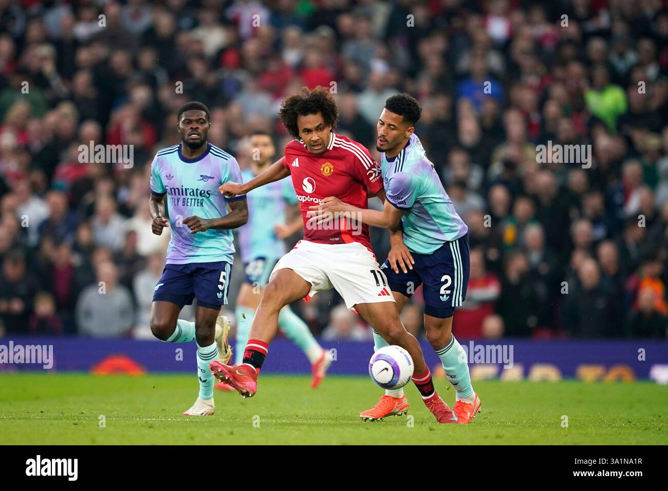 Arsenal's William Saliba, right, challenges Manchester United's Joshua ...