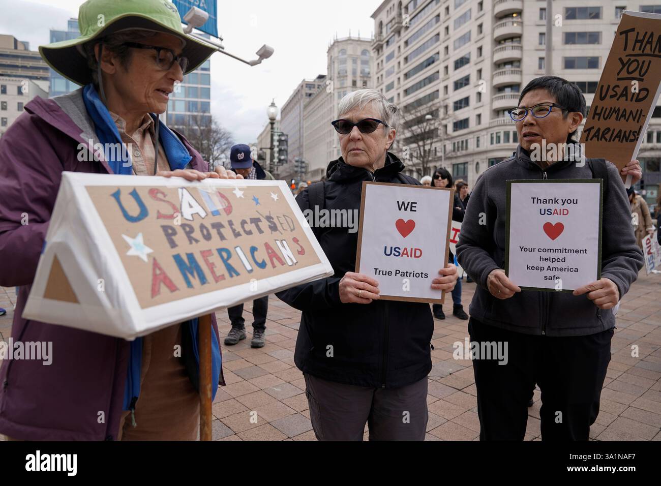 Supporters hold up their signs as United States Agency for ...