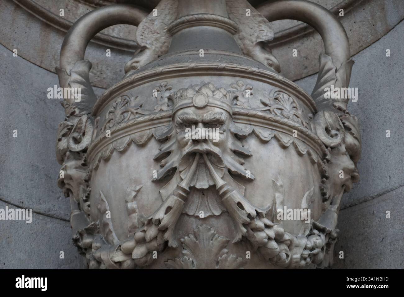 Close up of a medieval silver jug or pot ornamented with the face of an ...