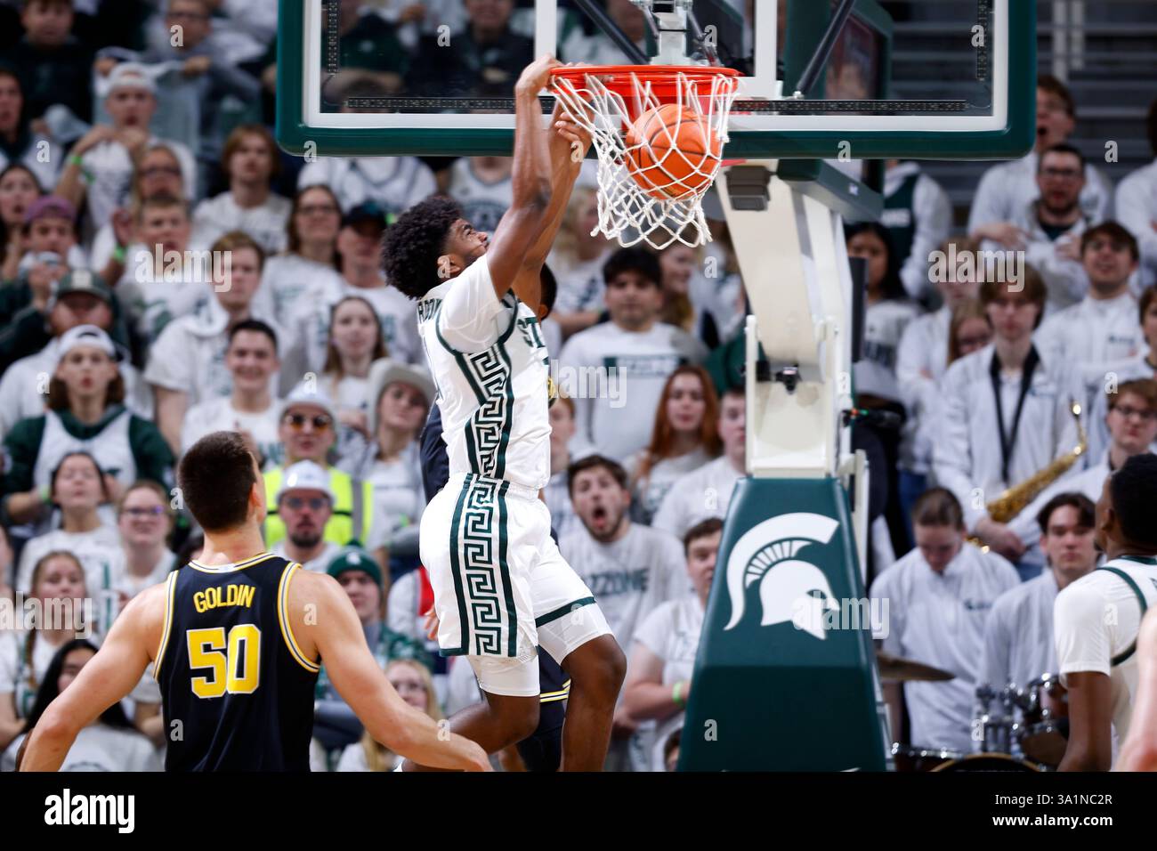 Michigan State guard Jase Richardson, center, dunks against Michigan ...