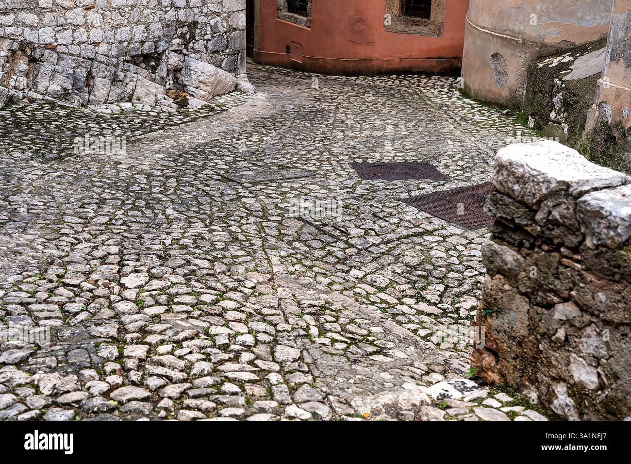 cobbled footpath downhill in an old Italian village. at the bottom of ...
