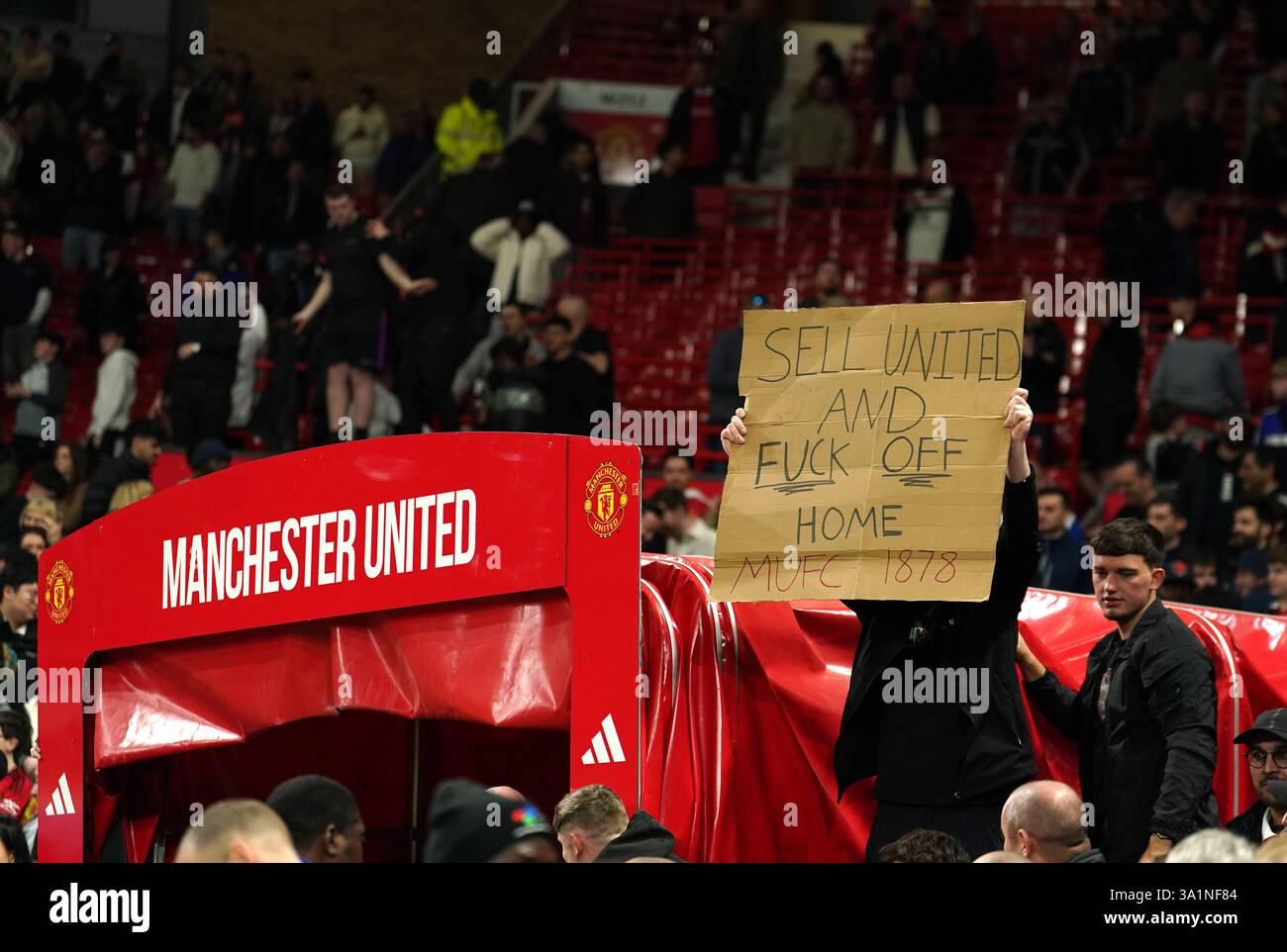 EDITORS NOTE: LANGUAGE: A fan holds a sign addressed to the owners of ...