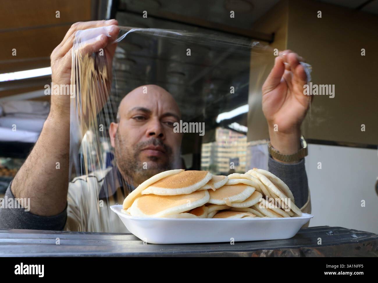 Bakers prepare dessert during Ramadan, Egypt An Egyptian baker prepares ...