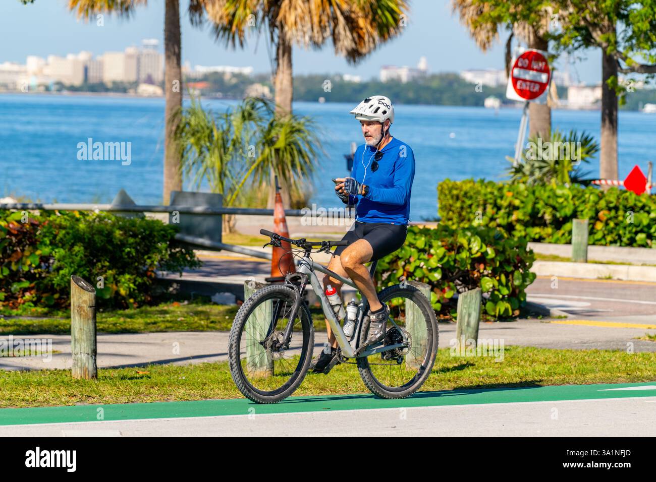 Key Biscayne Miami, FL, USA - March 8, 2025: Senior man riding a bike ...