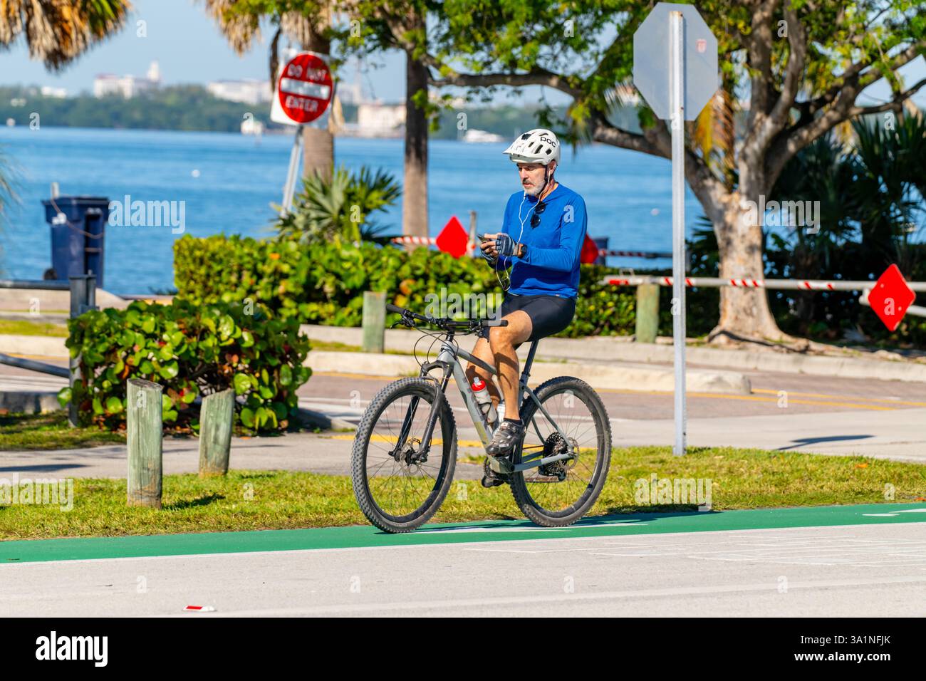 Key Biscayne Miami, FL, USA - March 8, 2025: Senior man riding a bike ...
