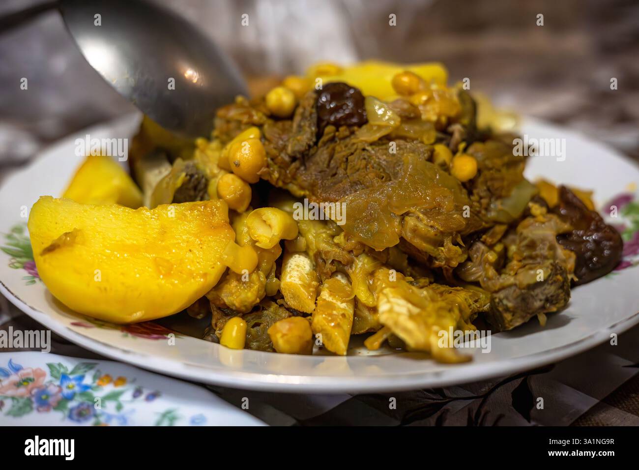 "Traditional Iranian Abgoosht (Dizi) served in a floral-patterned plate ...