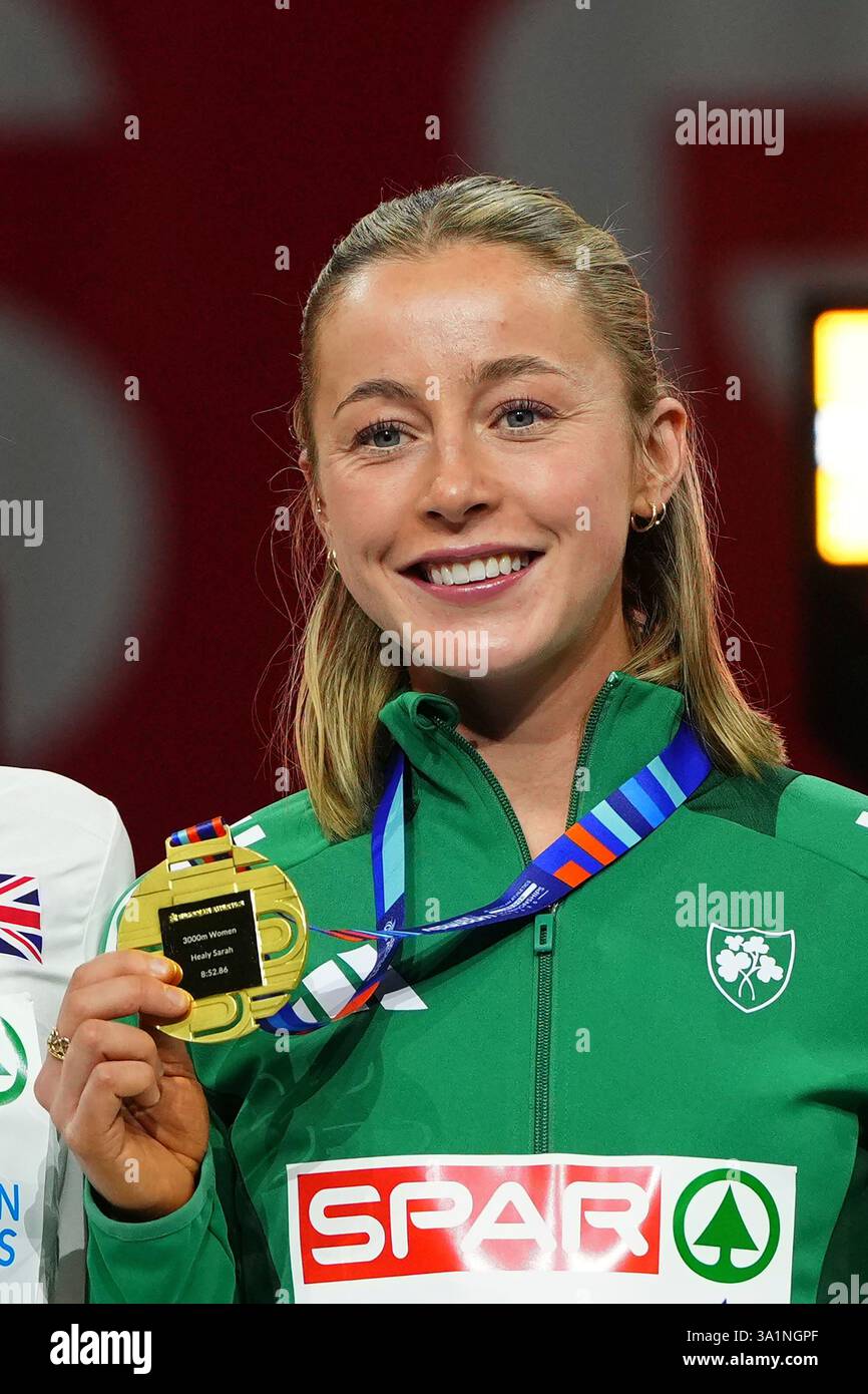 Winner Ireland's Sarah Healy celebrates on the podium for the 3000m ...