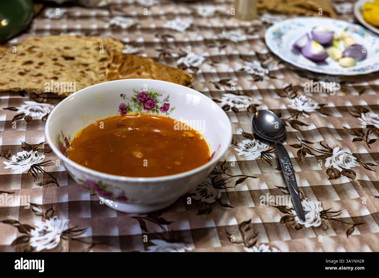"Traditional Iranian Abgoosht (Dizi) served in a floral-patterned plate ...
