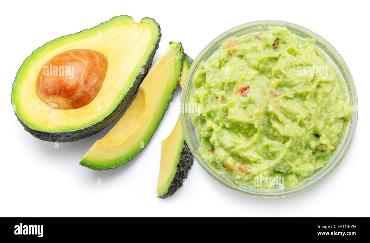 Guacamole and cross section of avocado fruit isolated on white ...
