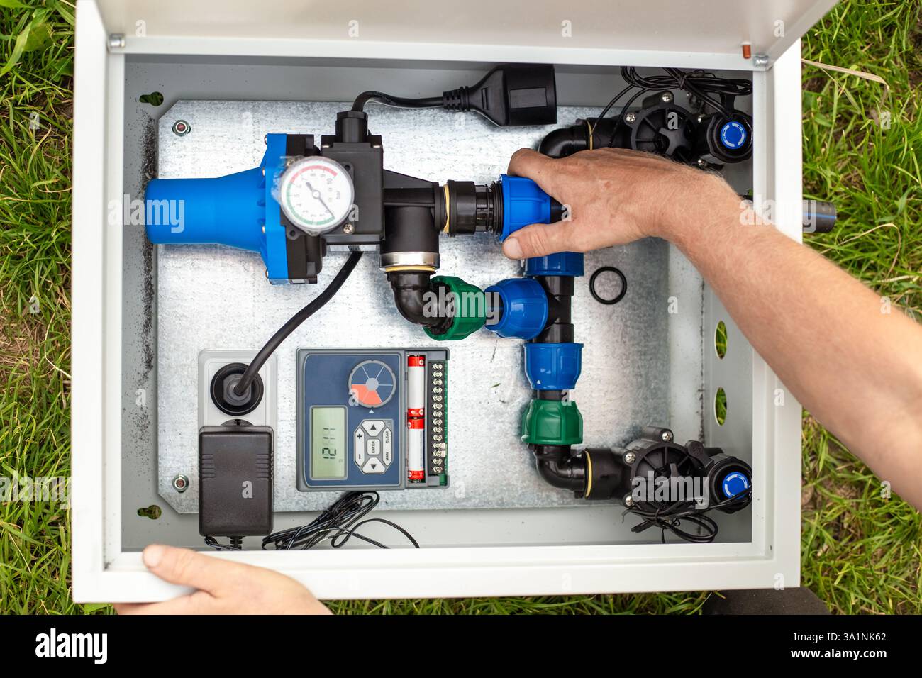 Installation of a drip irrigation system. A man assembles a system for ...