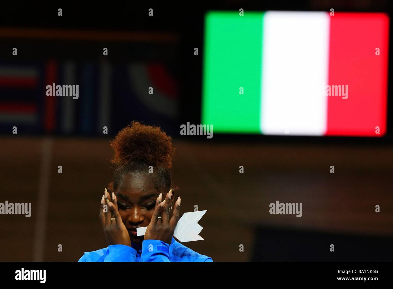 Winner Italy's Zaynab Dosso celebrates on the podium for the 60m Women ...
