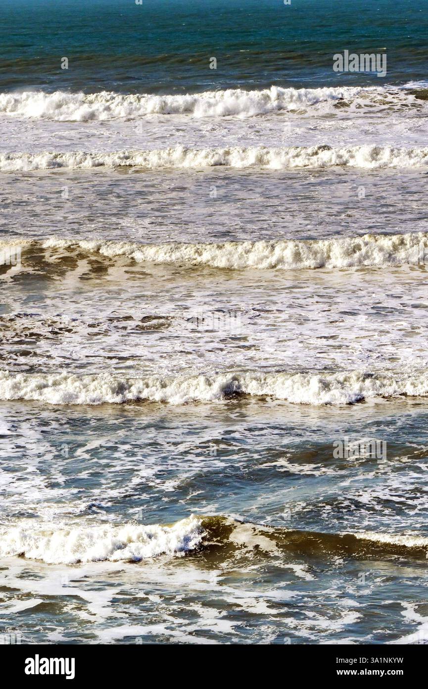 Waves rolling onto a beach. No people Stock Photo - Alamy