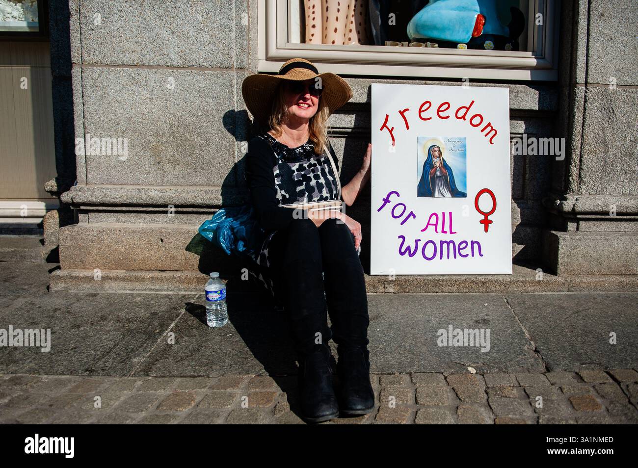 Amsterdam, Netherlands. 08th Mar, 2025. A woman is seen sitting next to ...