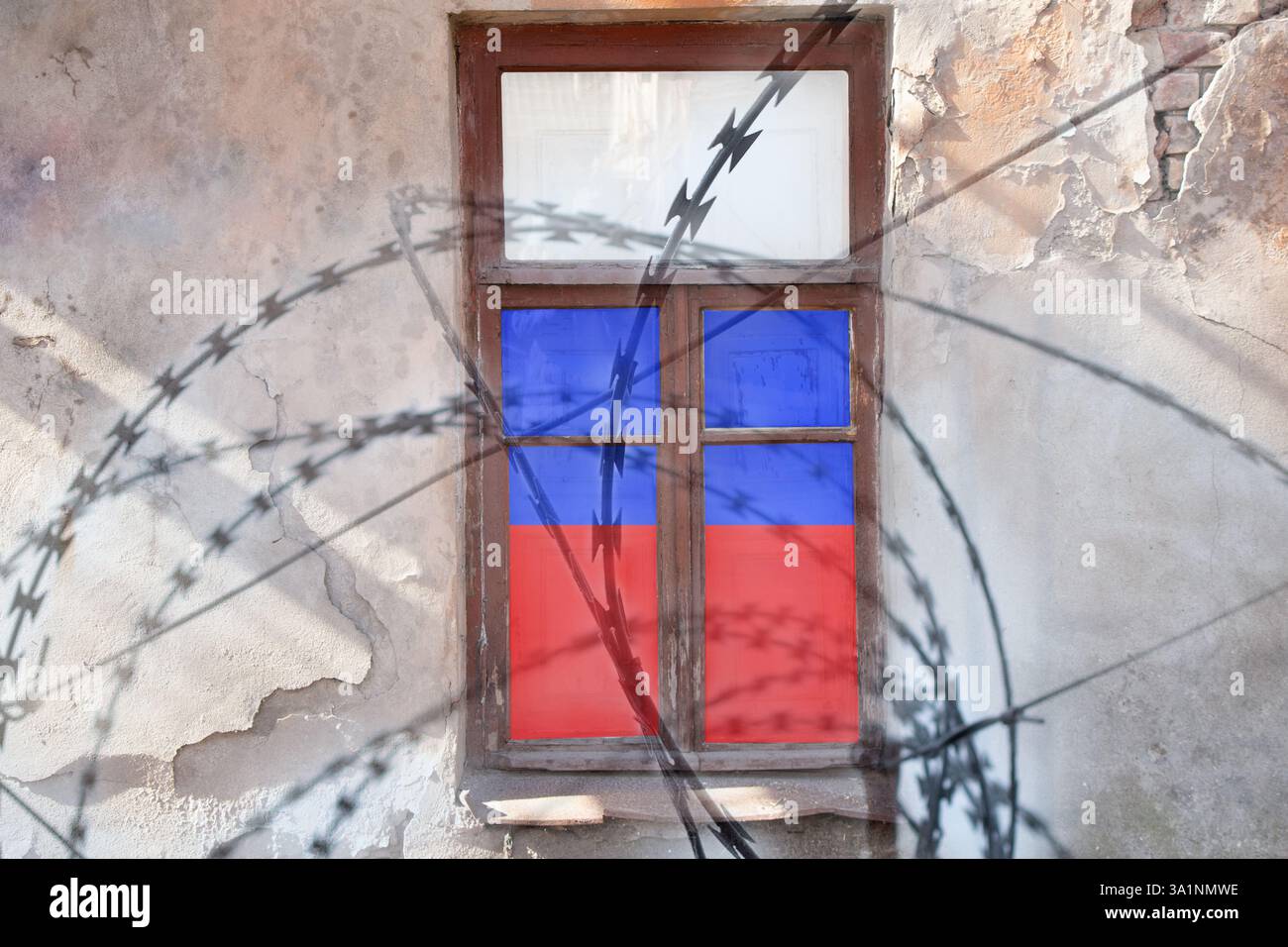 Window of an old house and a Russian flag in the window against the ...