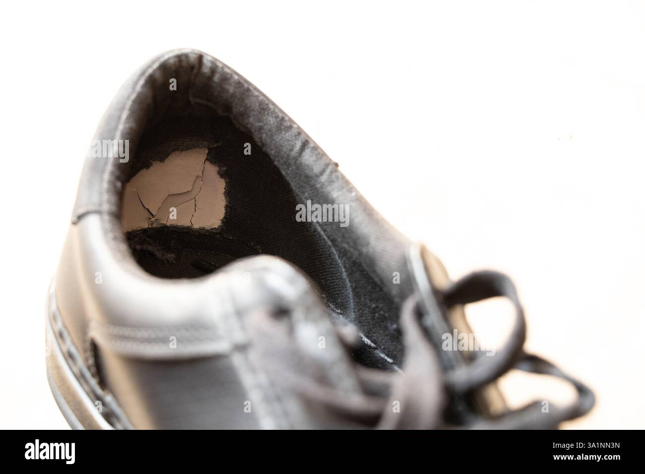 Torn heel in black sneakers inside, torn shoes, wear of poor quality ...