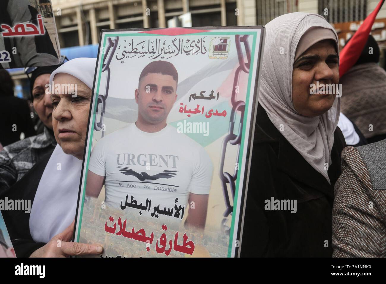 Nablus, Palestine. 09th Mar, 2025. A Palestinian woman holds a picture of her imprisoned son who ...