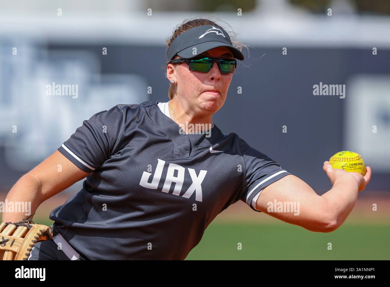 Jacksonville first baseman Tatum McCool (12) warms up before an NCAA ...