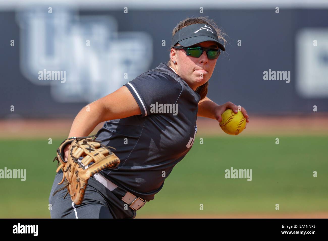 Jacksonville first baseman Tatum McCool (12) warms up before an NCAA ...