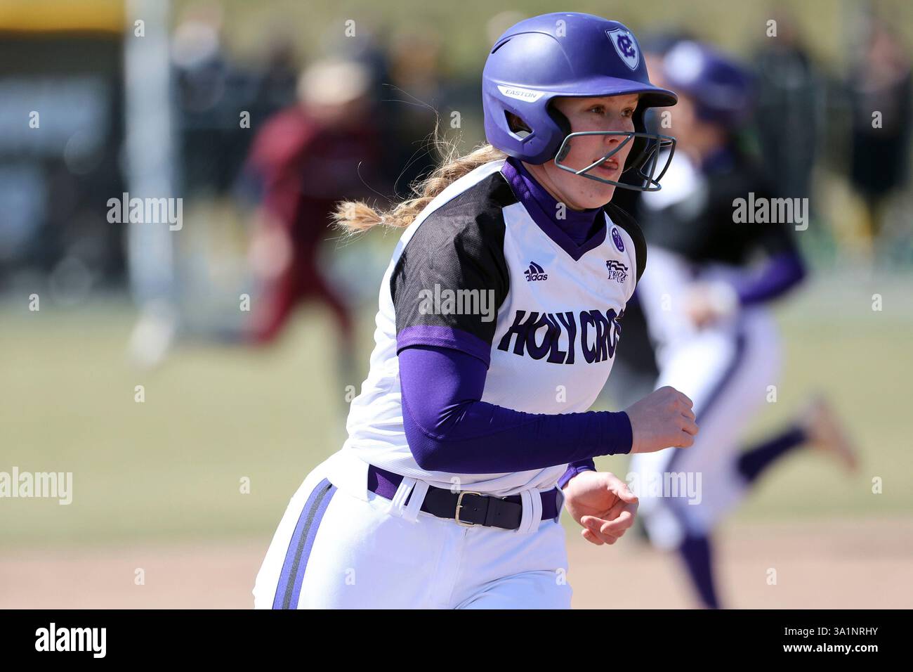 Holy Cross infielder Anna Brait (18) rounds third base during an NCAA ...