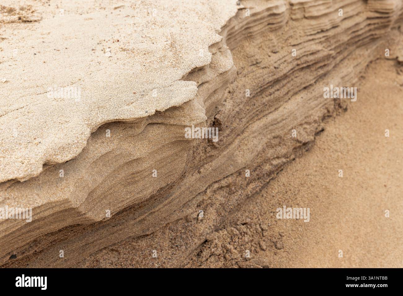 View of distinct horizontal layers of sand exposed through natural ...
