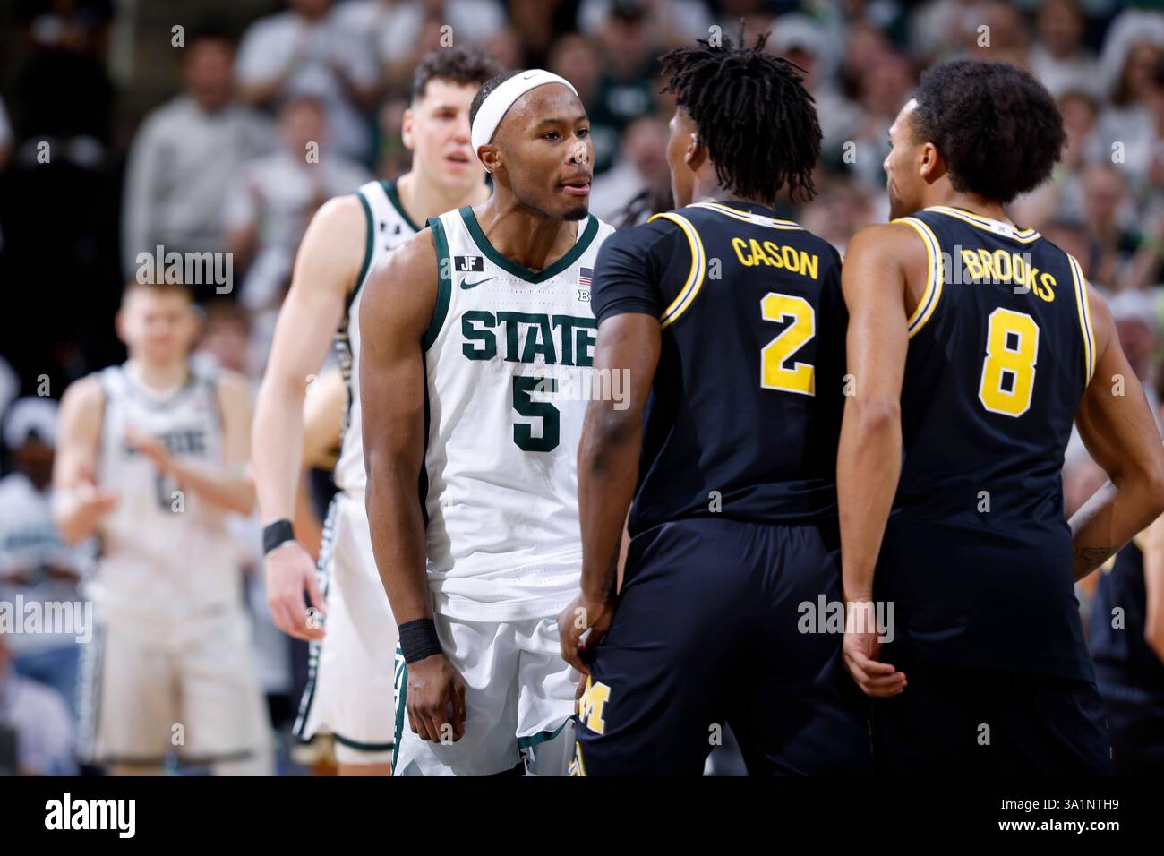 Michigan State guard Tre Holloman (5) and Michigan guards L.J. Cason (2 ...